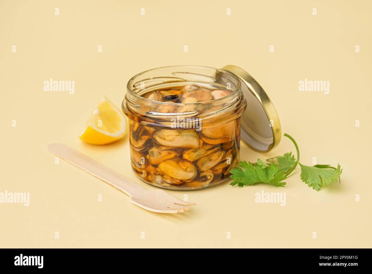 Jar with pickled mussels on beige background Stock Photo - Alamy