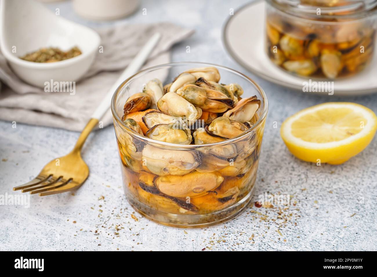 Jar and glass bowl with pickled mussels on grey background Stock Photo ...