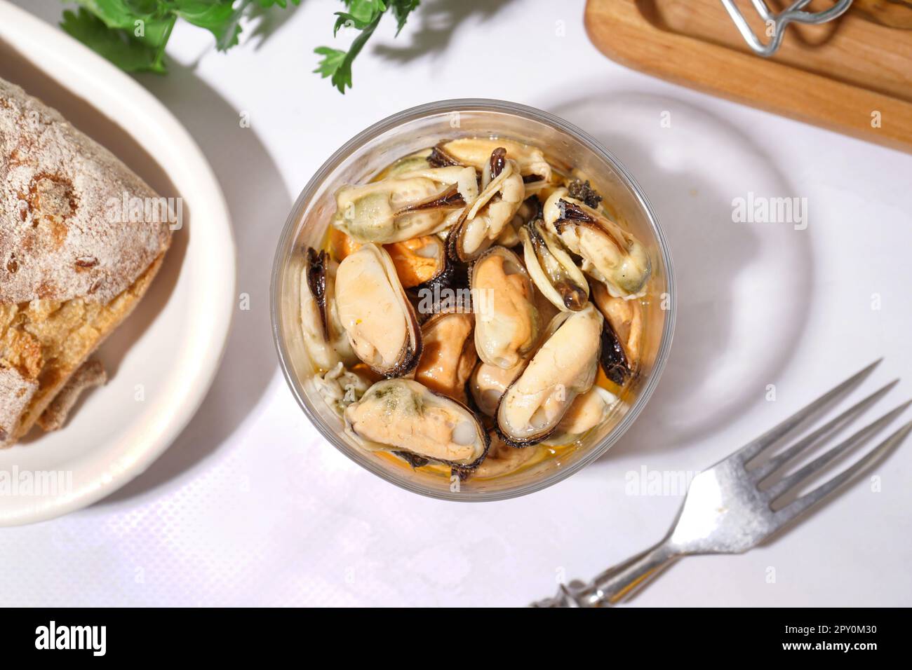 Glass bowl with pickled mussels on white background Stock Photo - Alamy