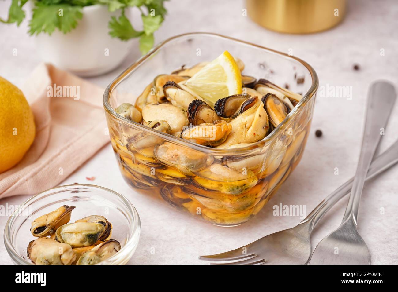 Bowls with pickled mussels on white background Stock Photo - Alamy
