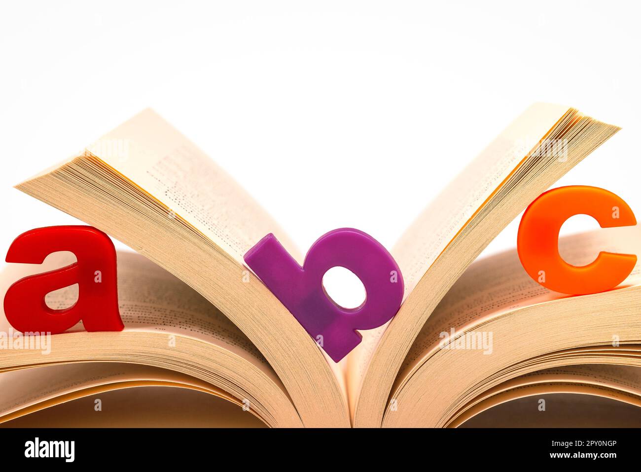Colored alphabet letters ABC on the open book pages. Education concept ...