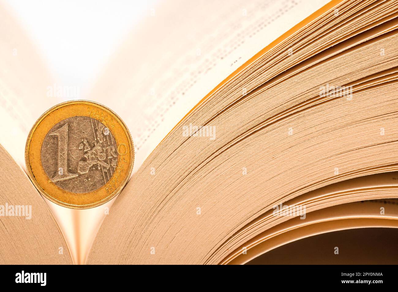 Open book with one Euro coin. Reading makes you richer- concept Stock ...
