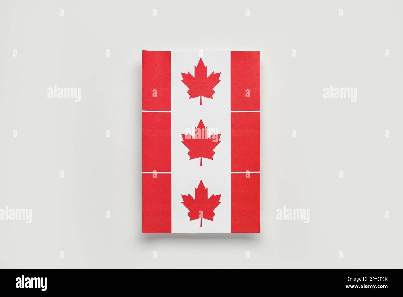 Paper flags of Canada on white background Stock Photo - Alamy