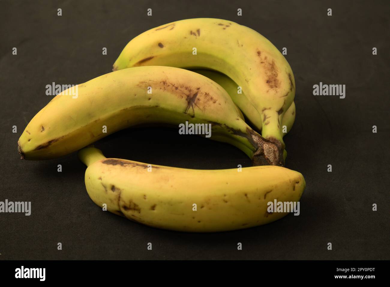 A hand of bananas from the Canary Islands (Spain) with small spots that ...