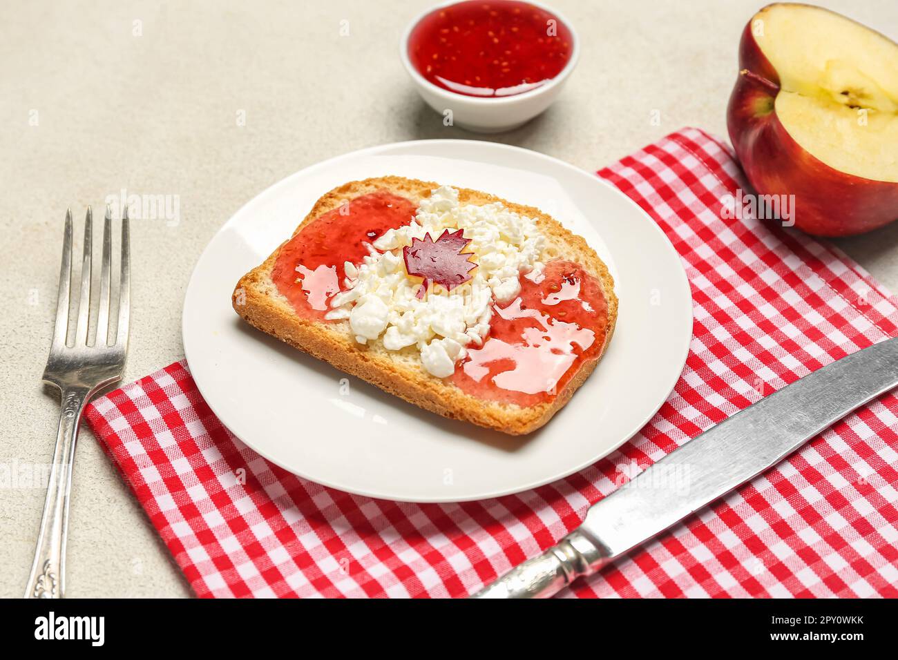 Table setting with tasty toast on white background. Canadian flag ...