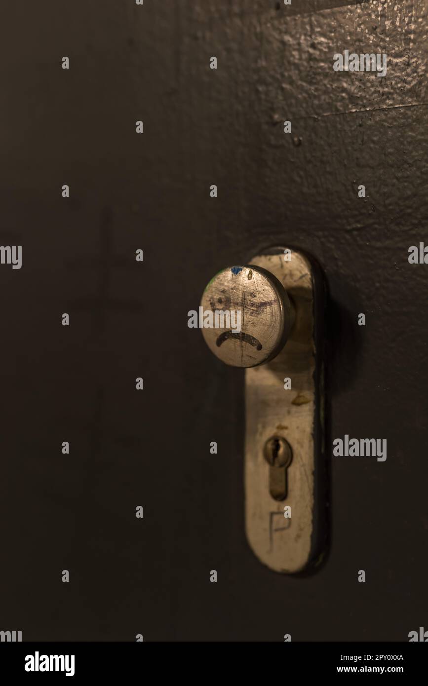 A doorknob with a bad tempered face painted on it Stock Photo - Alamy
