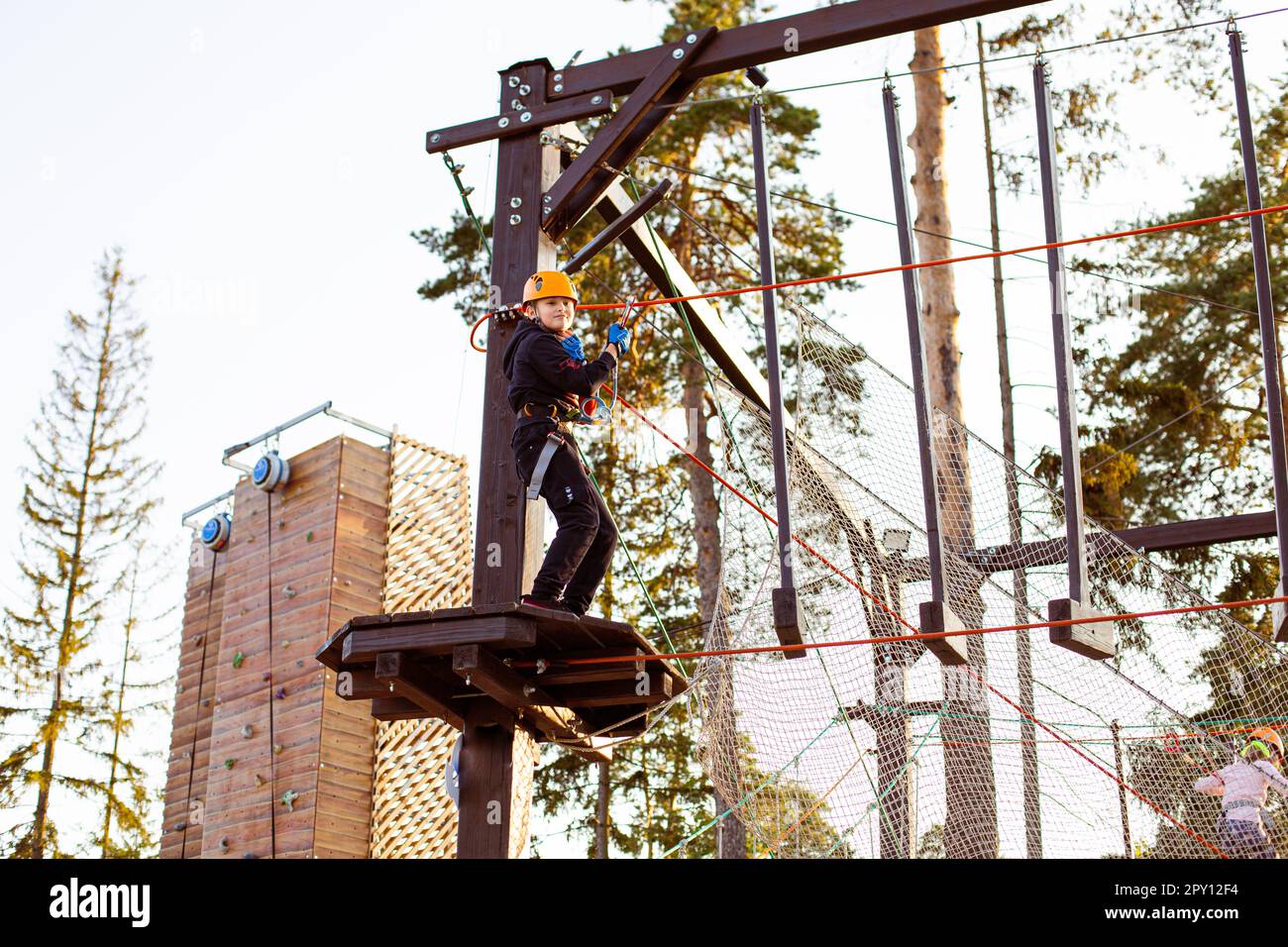 Active children's recreation. Climbing the rope park Stock Photo - Alamy