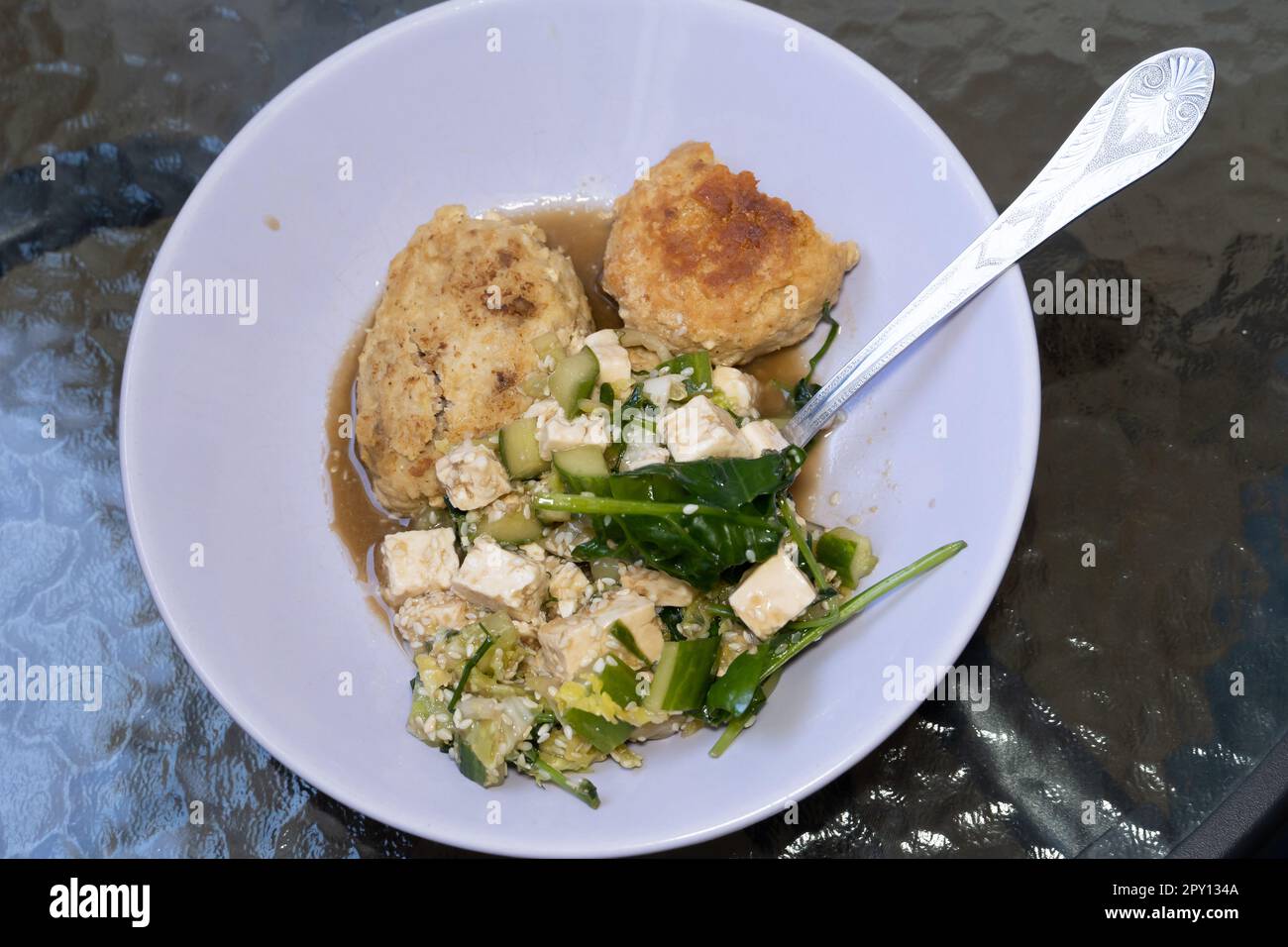 Plate with cutlets and salad on a glass table. Healthy food. A quick ...