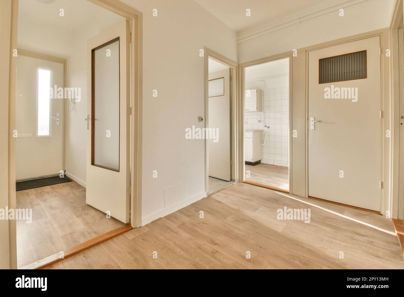 an empty room with white walls and wood flooring on the right side ...