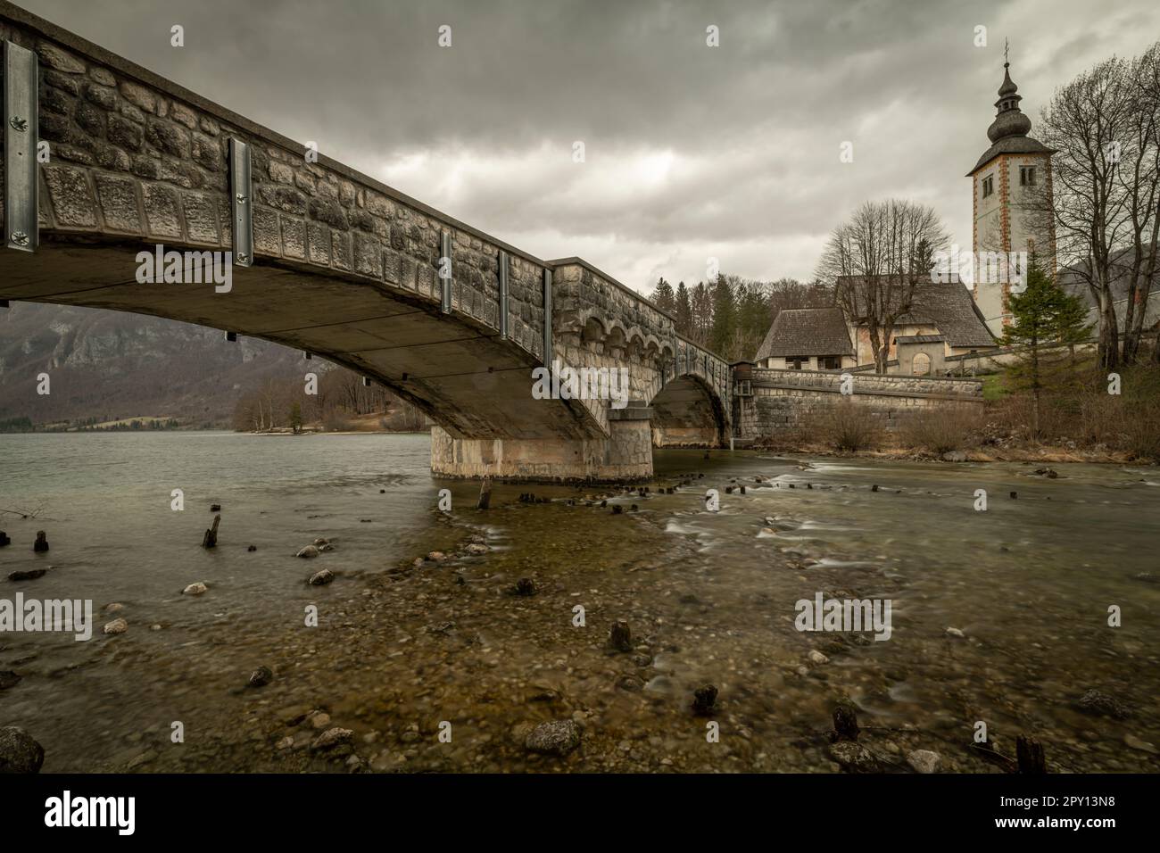 Dark cloudy sunny evening with no colors near Bohinj lake with old ...