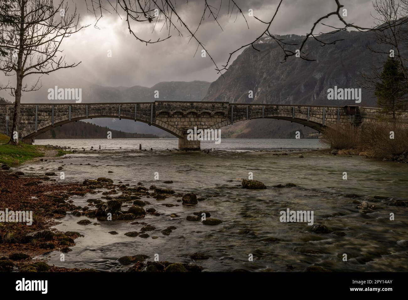 Dark cloudy sunny evening with no colors near Bohinj lake with old ...