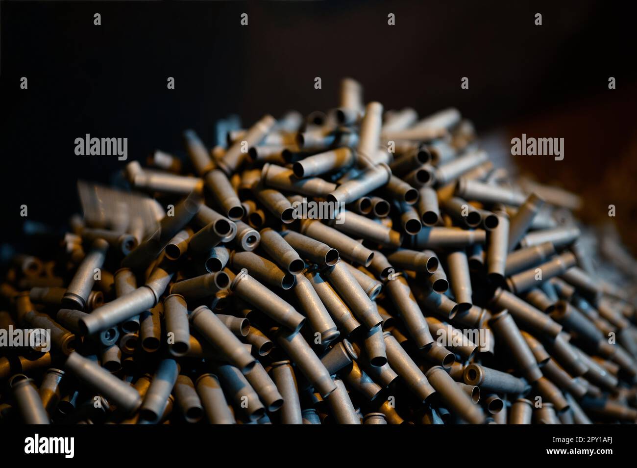 Bullet casings pile in weapon production plant storage Stock Photo - Alamy