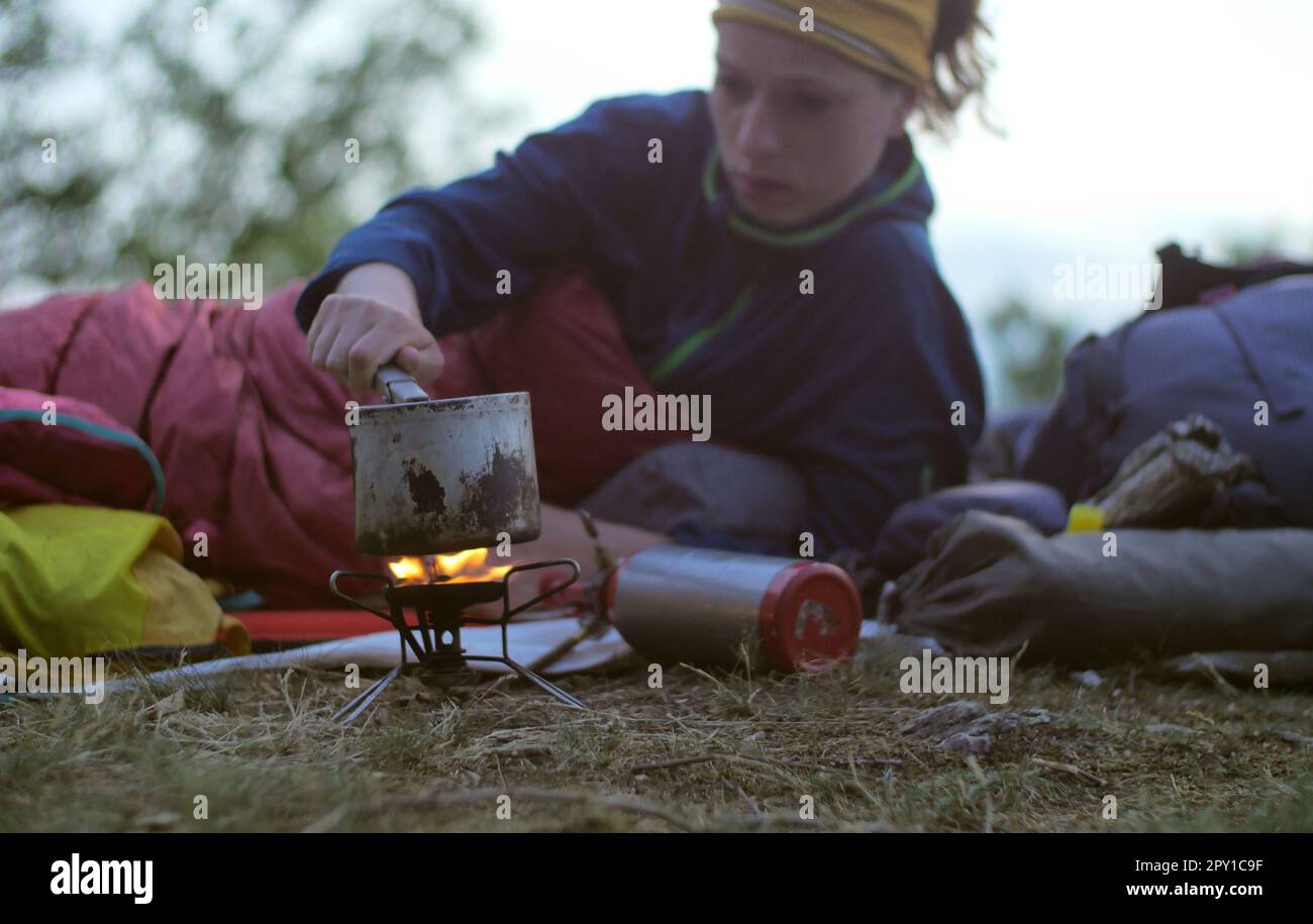female hiker cooking outdoors Stock Photo - Alamy
