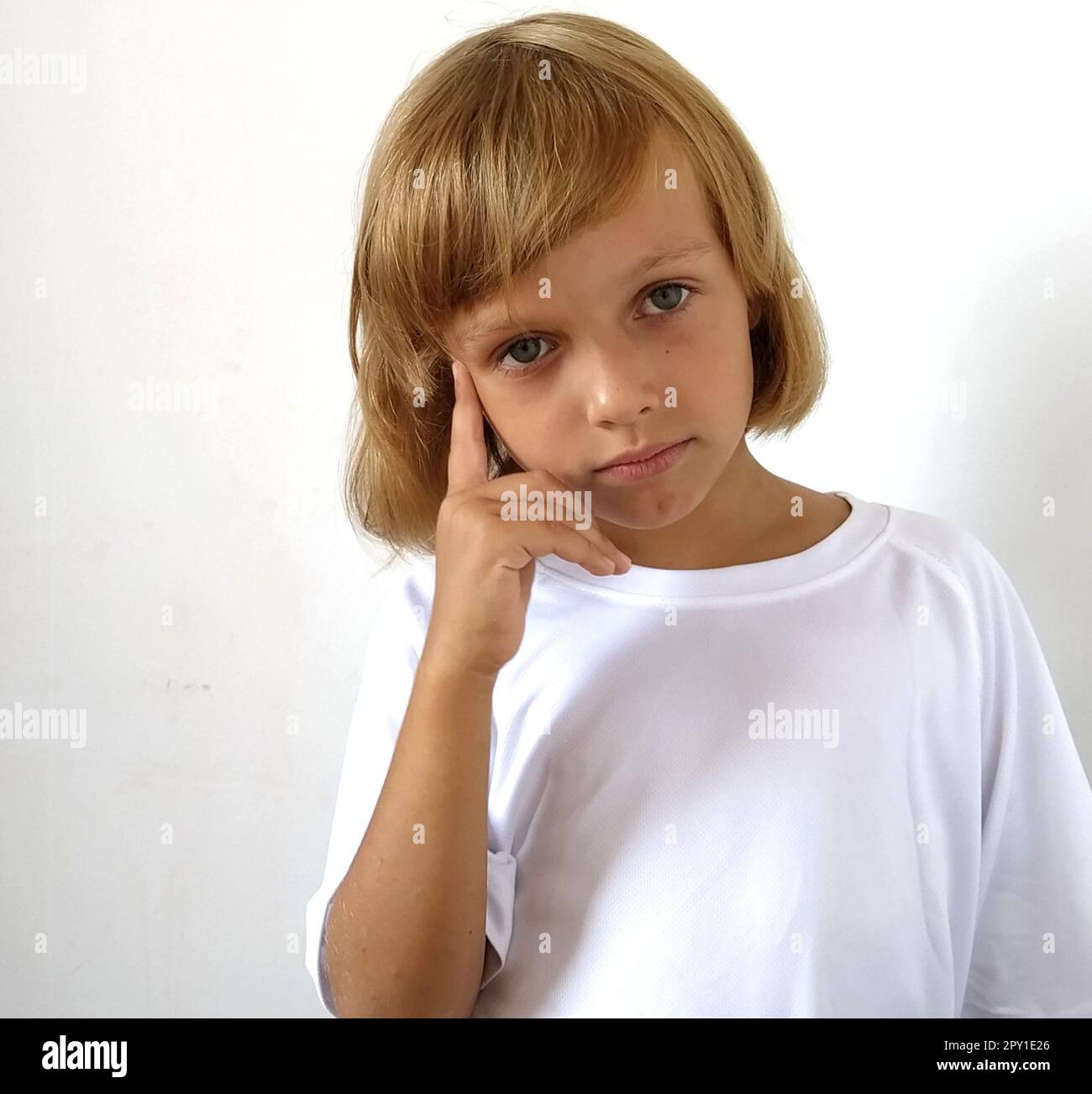 Little cute girl 6-7 years old with blond hair on a white background ...
