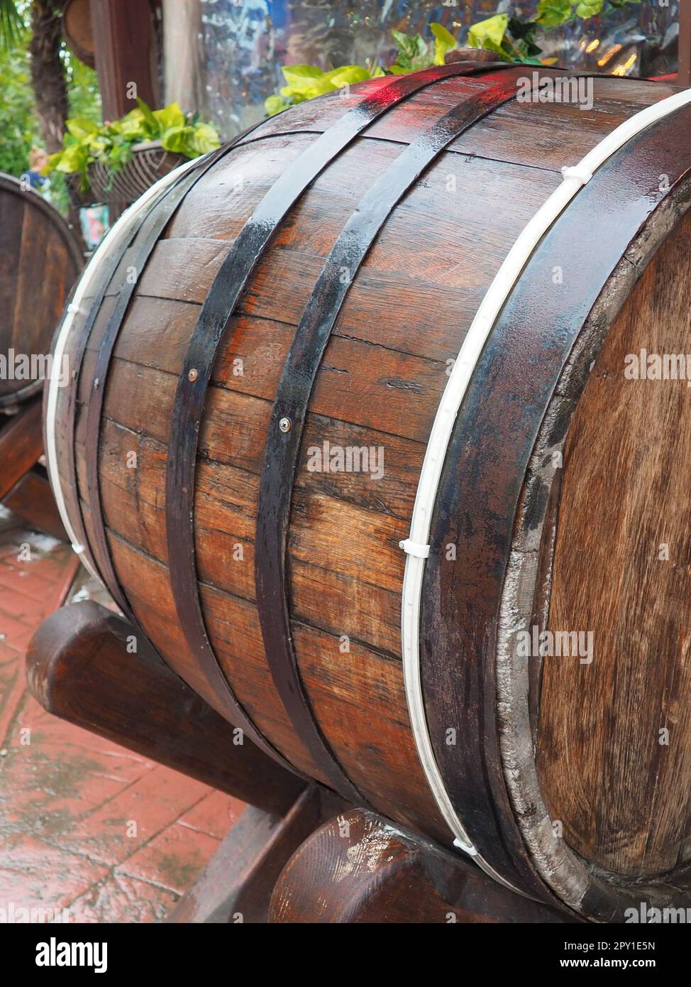 A traditional old wooden barrel with curved walls and metal hoops ...