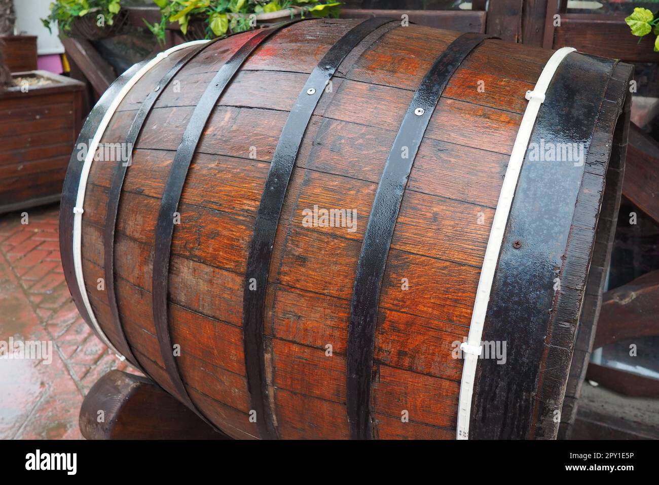 A traditional old wooden barrel with curved walls and metal hoops ...