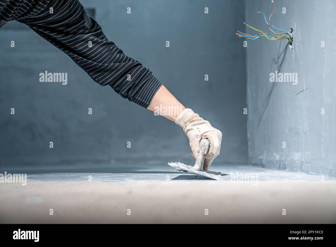 manual application of waterproofing to the floor on the construction ...