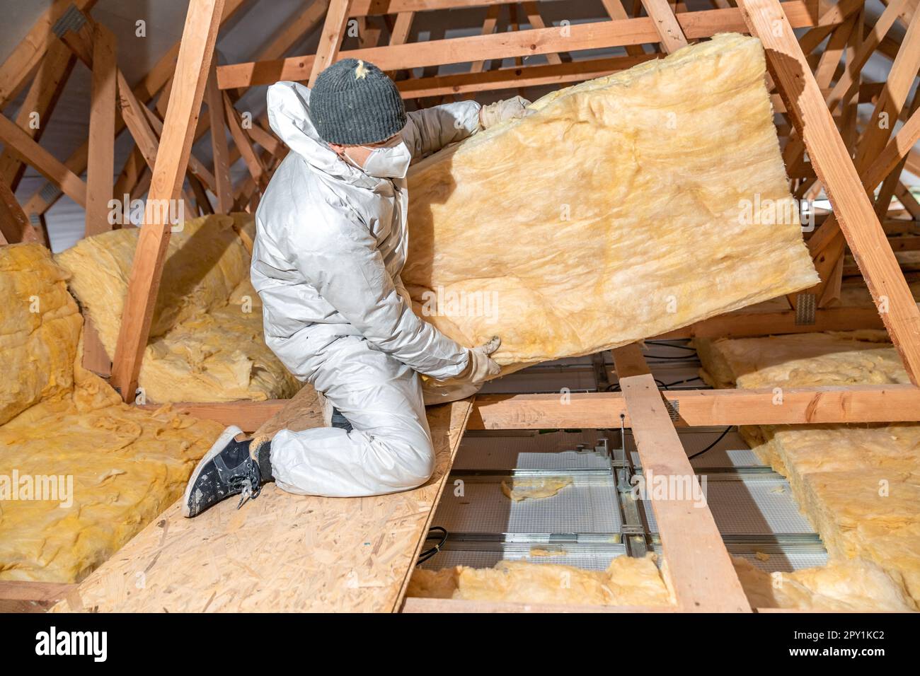 insulation of the roof and ceiling with glass wool Stock Photo - Alamy