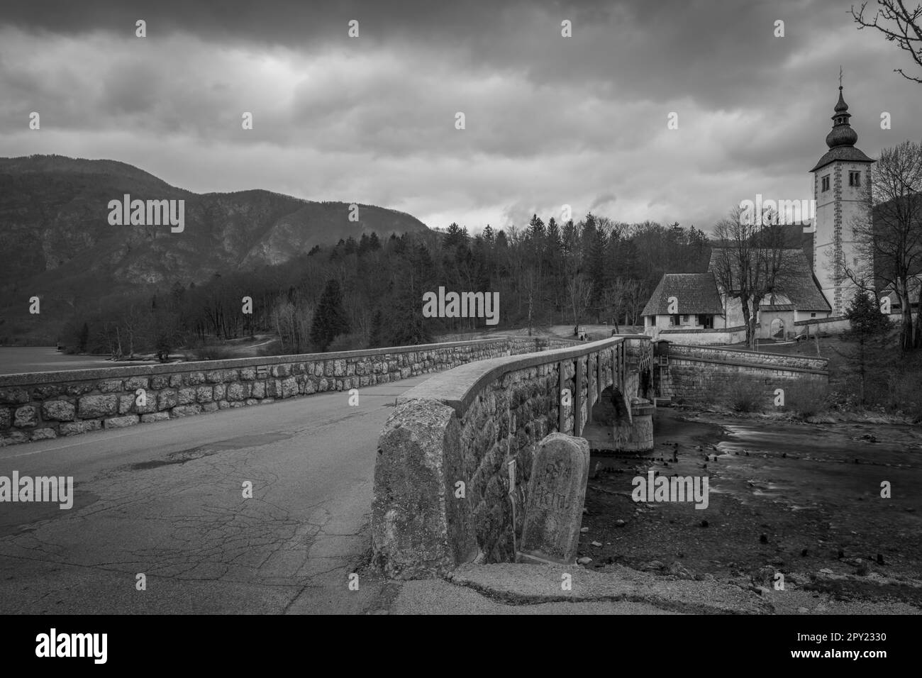 Dark cloudy sunny evening with no colors near Bohinj lake with old ...