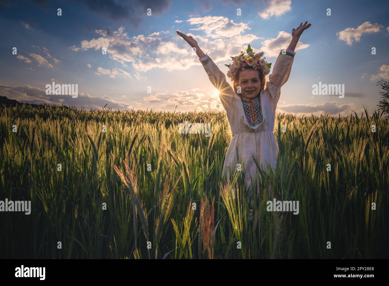 Beautiful young girl with flower chaplet, ethnic folklore dress with ...
