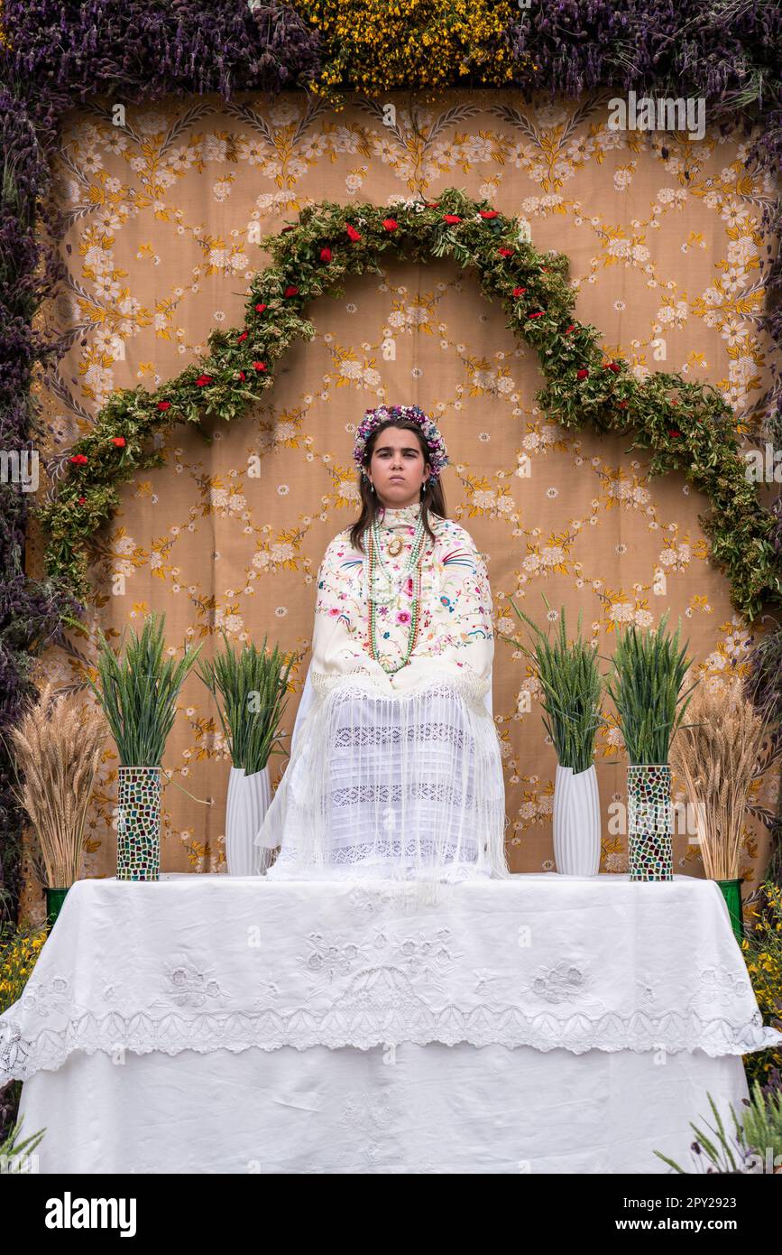 A Maya girl is seen seated at an altar during the traditional ...