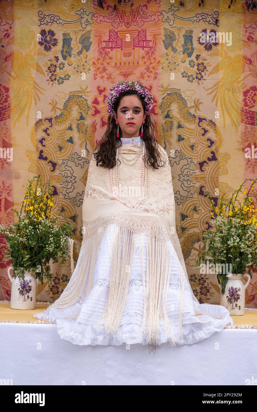 A Maya girl is seen seated at an altar during the traditional ...