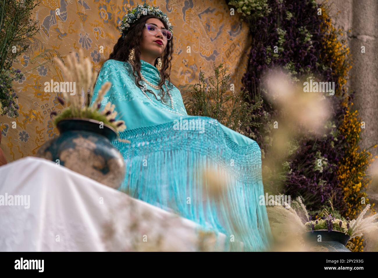 A Maya girl is seen seated at an altar during the traditional ...