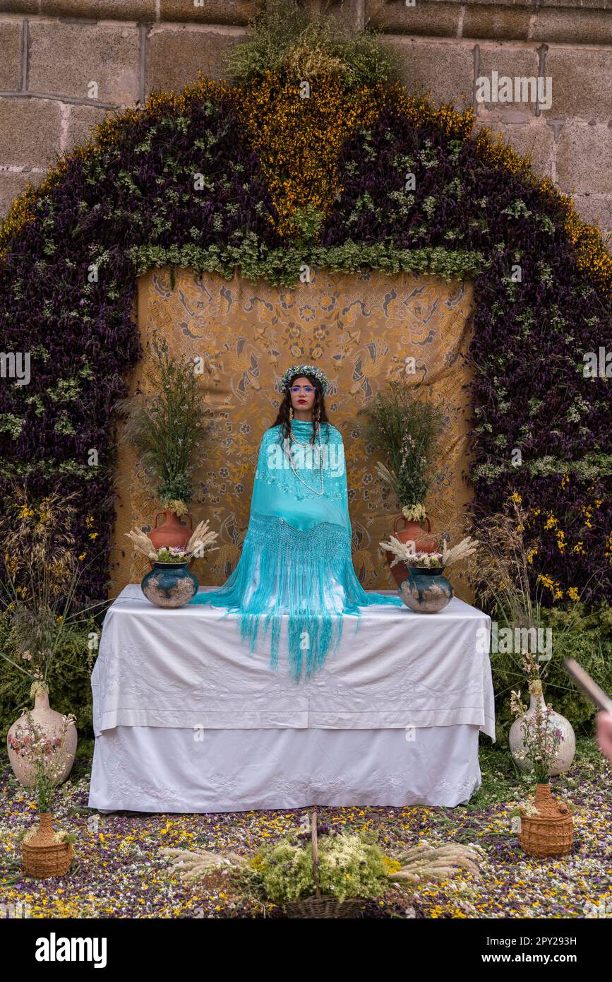 A Maya girl is seen seated at an altar during the traditional ...