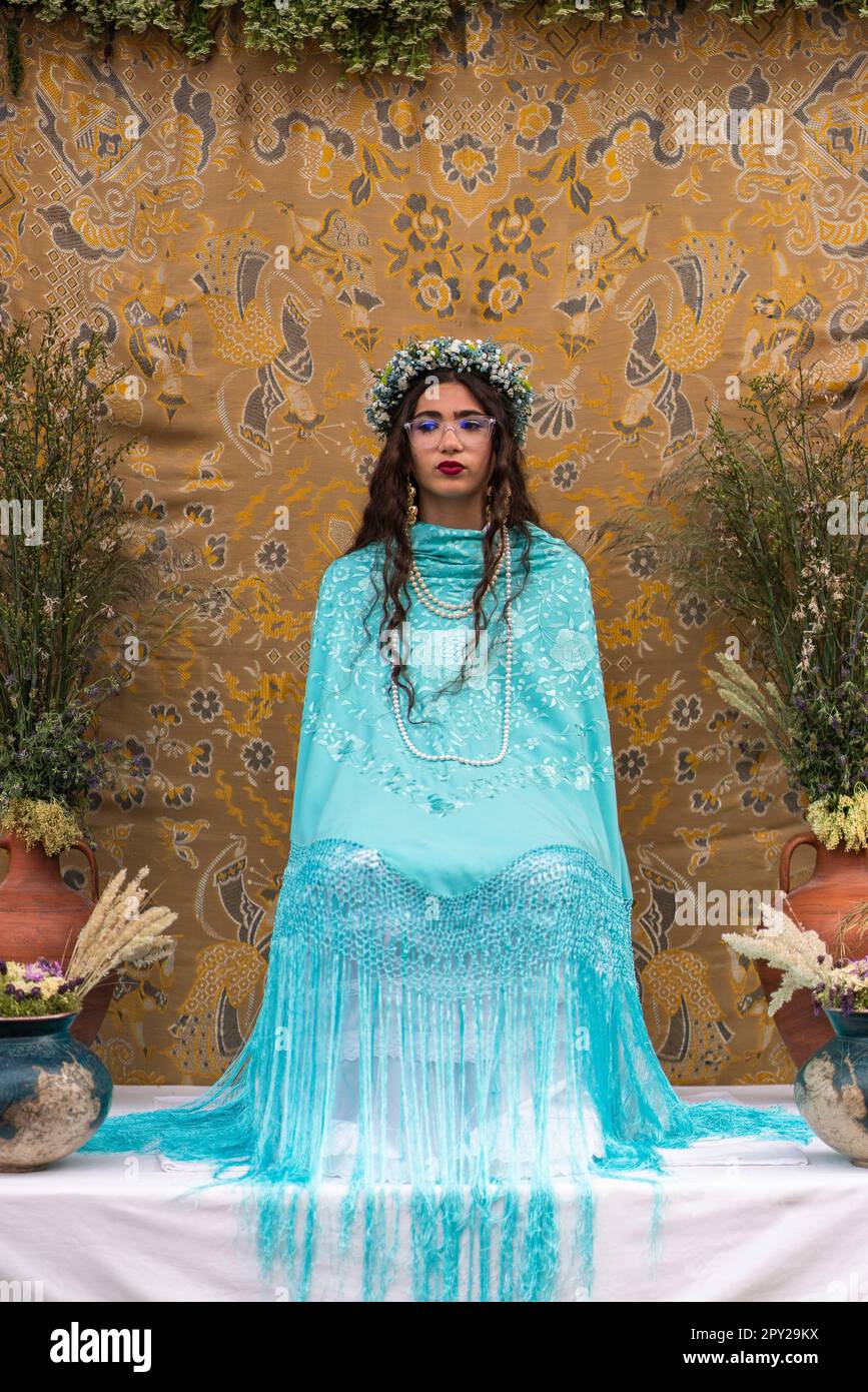 A Maya girl is seen seated at an altar during the traditional ...