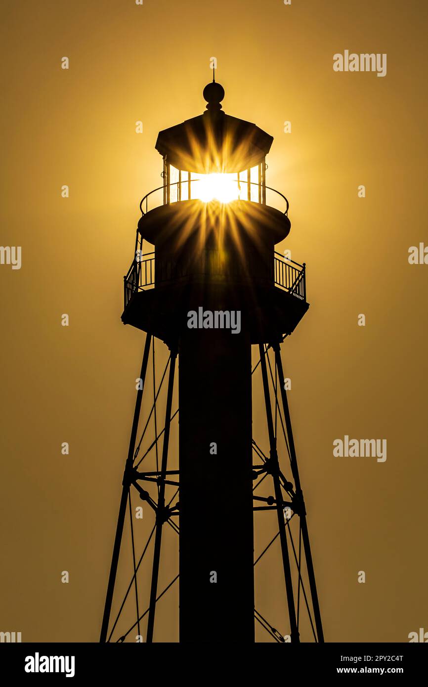 Silhouette of Sanibel Island Lighthouse with sun rays bursting through ...