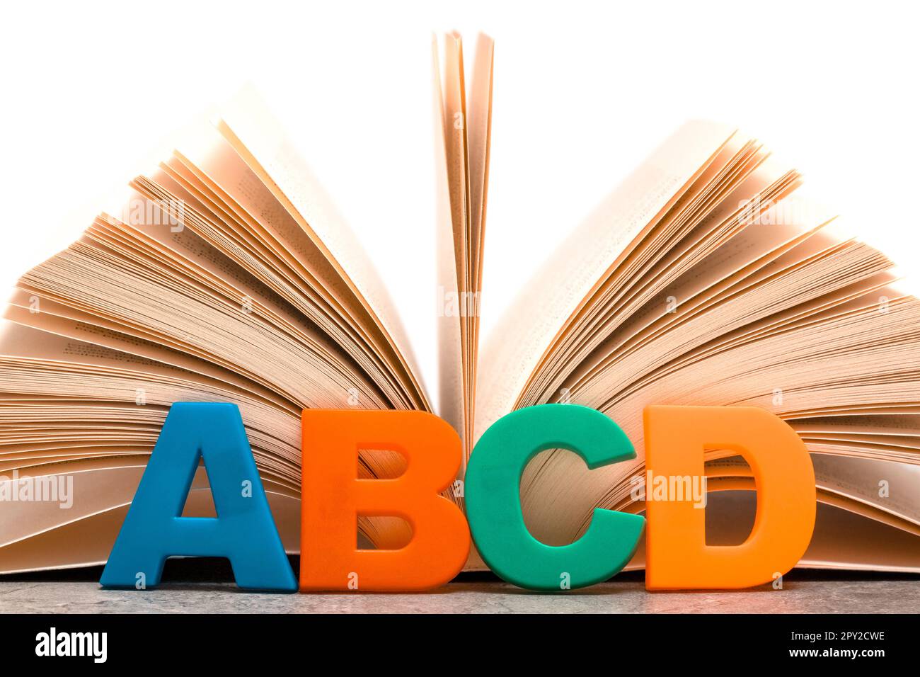 Alphabet letters ABCD and open book. Education concept Stock Photo - Alamy