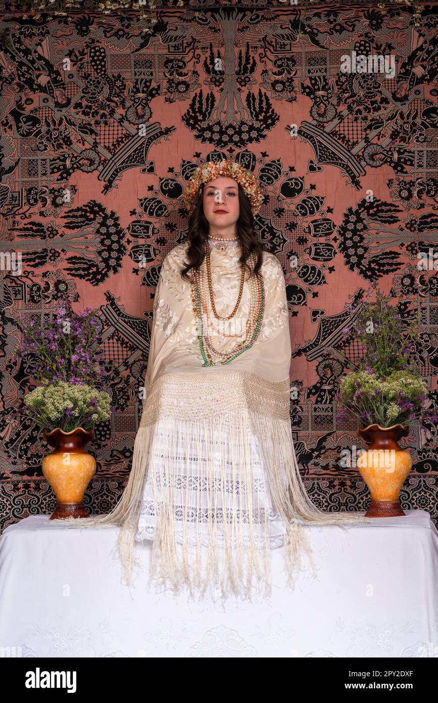 A Maya girl is seen seated at an altar during the traditional ...