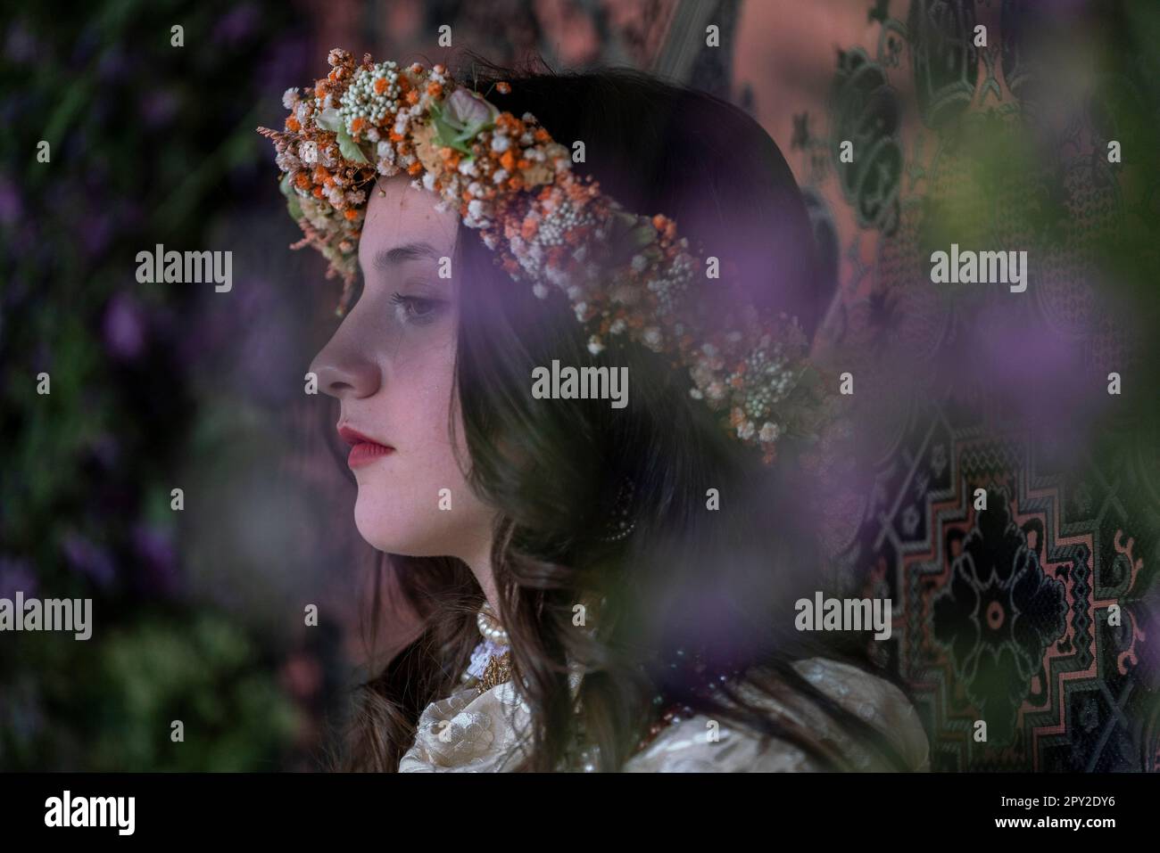 A Maya girl is seen seated at an altar during the traditional ...