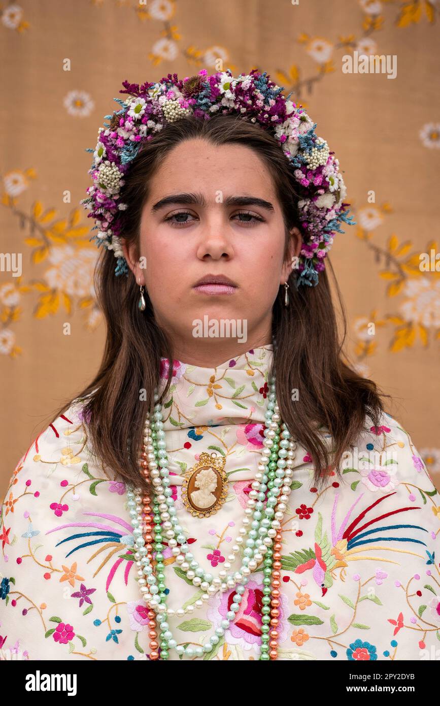 A Maya girl is seen seated at an altar during the traditional ...