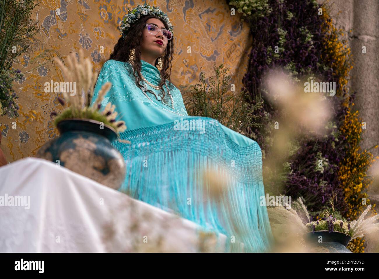 A Maya girl is seen seated at an altar during the traditional ...