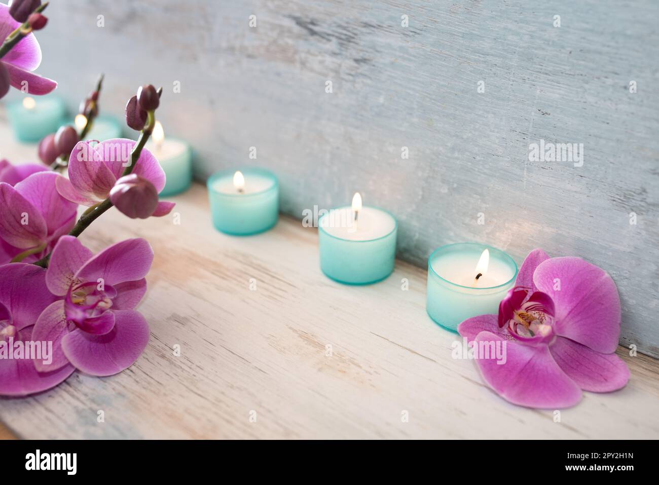 Spa decoration with purple orchids and candle lights on gray vintage ...