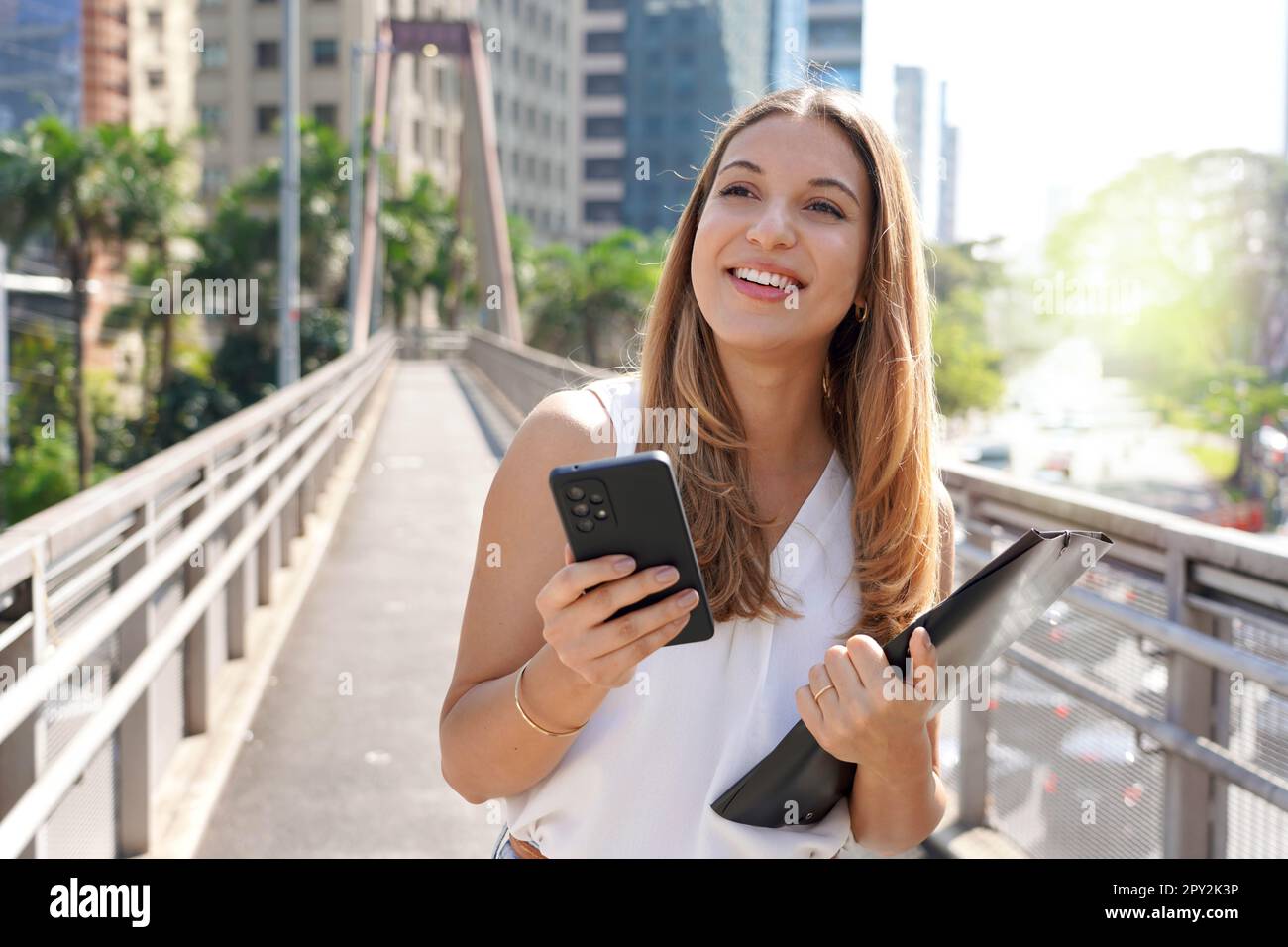 Happy business woman walking outside in financial district Stock Photo ...