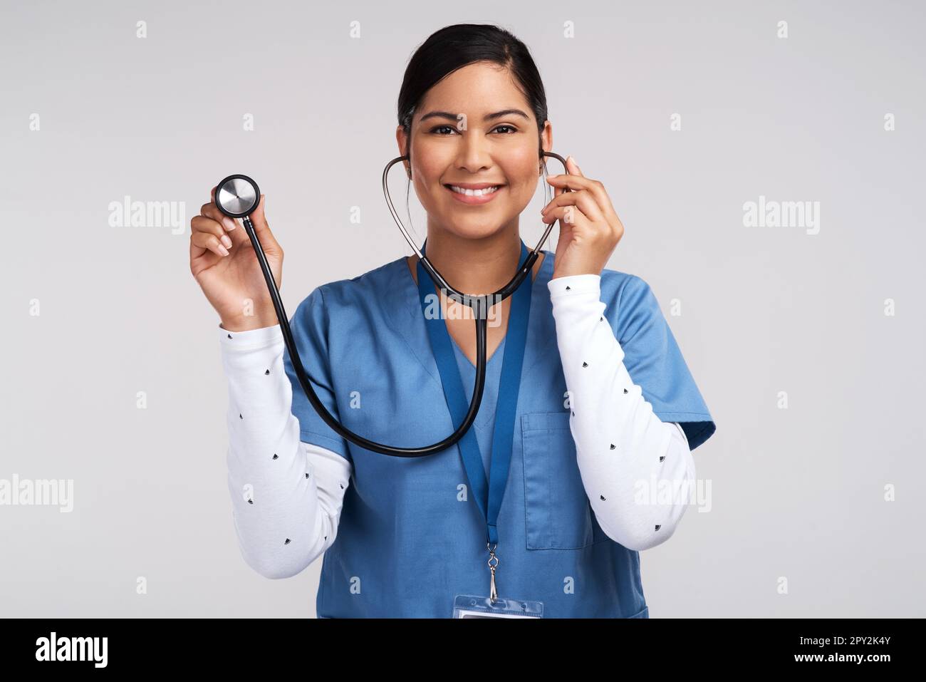 My stethoscope, my jewellery. Portrait of a young doctor using a ...