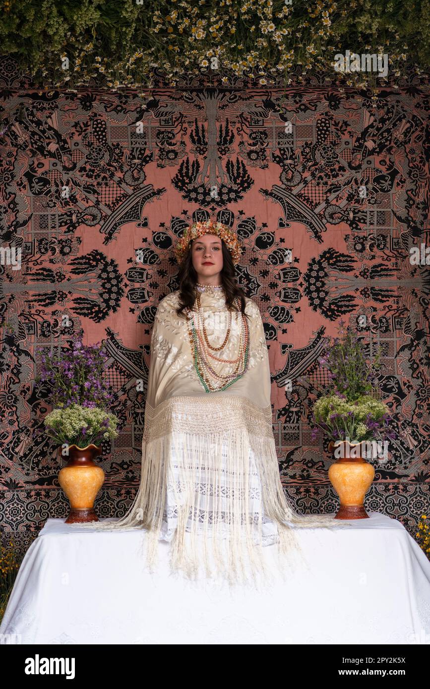 A Maya girl is seen seated at an altar during the traditional ...