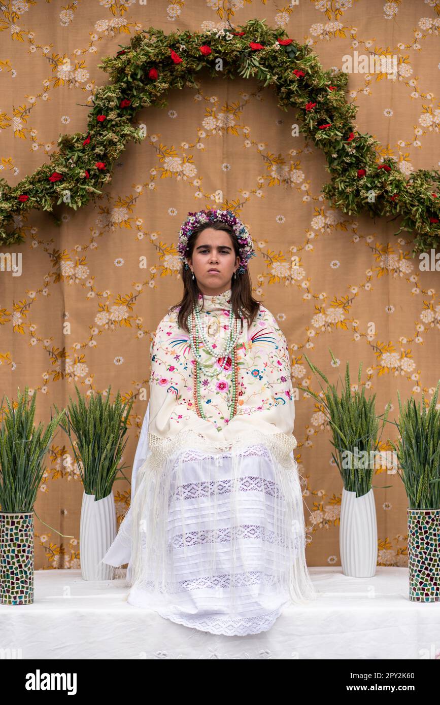 A Maya girl is seen seated at an altar during the traditional ...