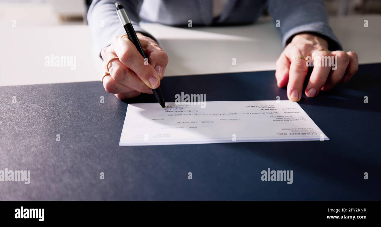 Payrol Compensation Bank Cheque. Cashing Money Check Stock Photo - Alamy
