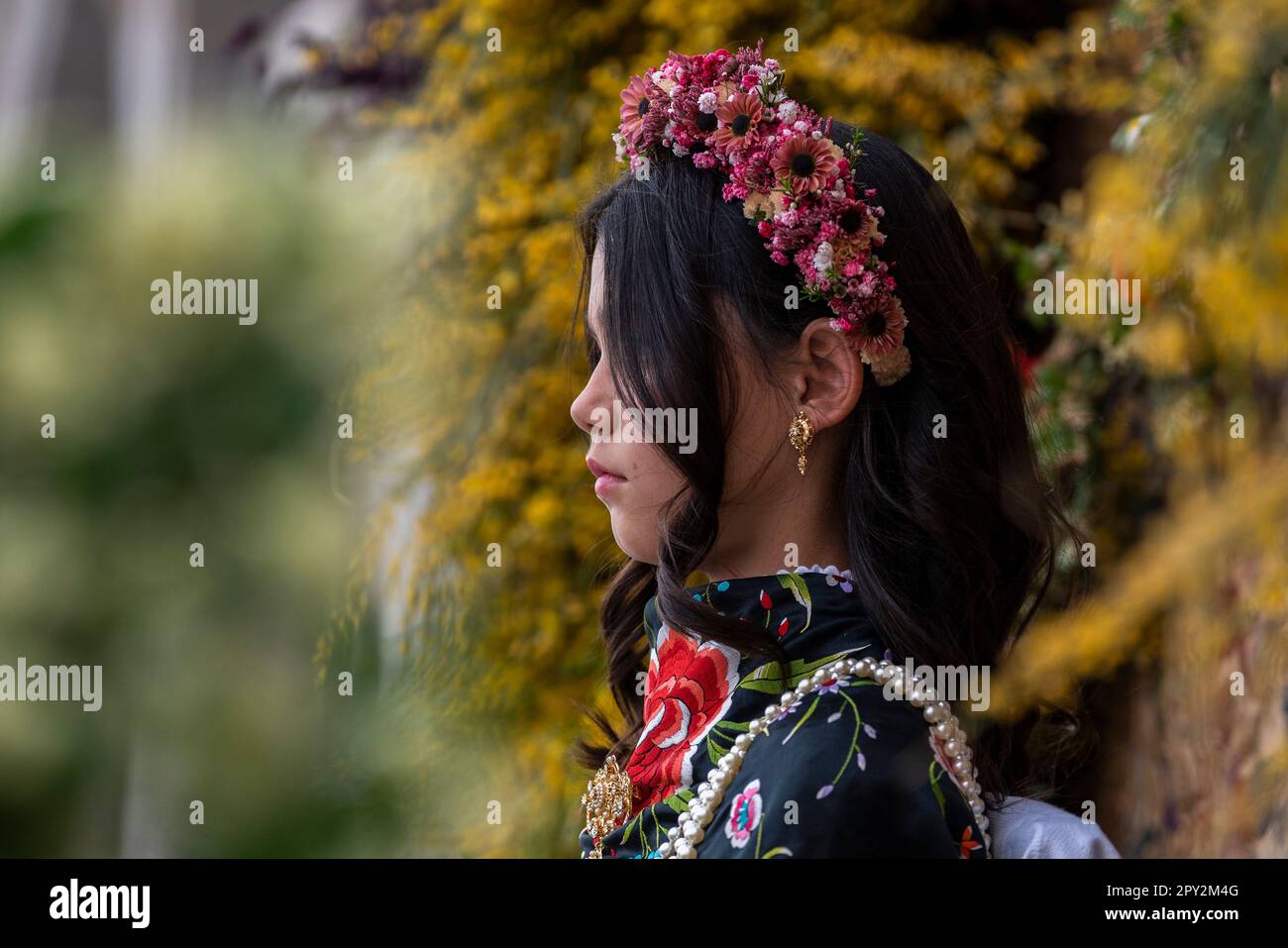 A Maya girl is seen seated at an altar during the traditional ...