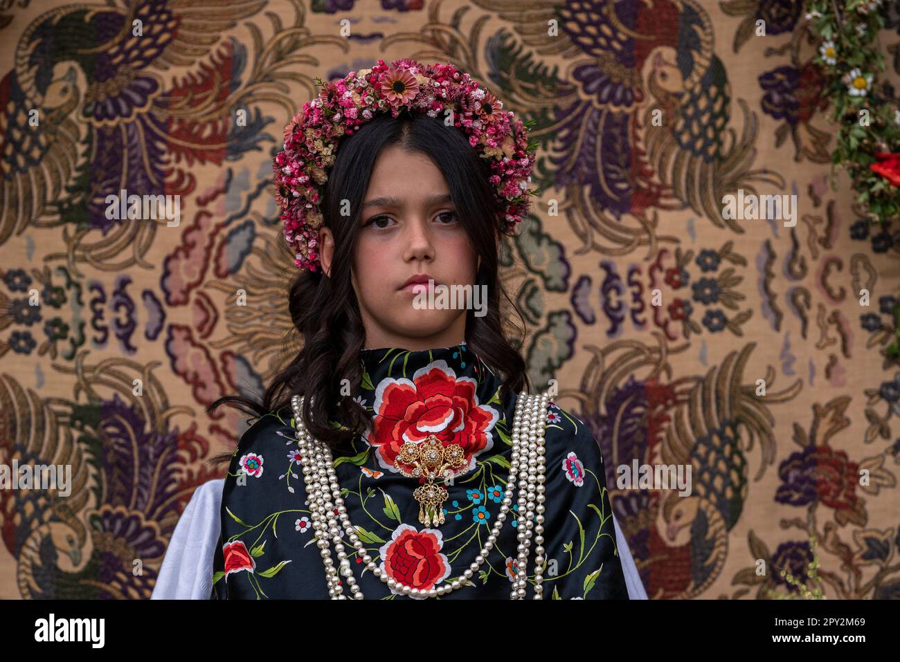 A Maya girl is seen seated at an altar during the traditional ...