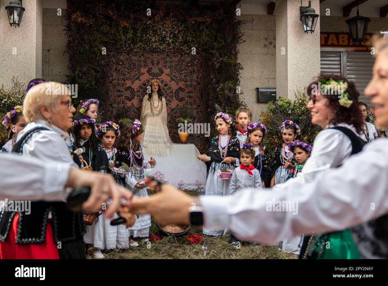 A Maya girl is seen seated at an altar during the traditional ...