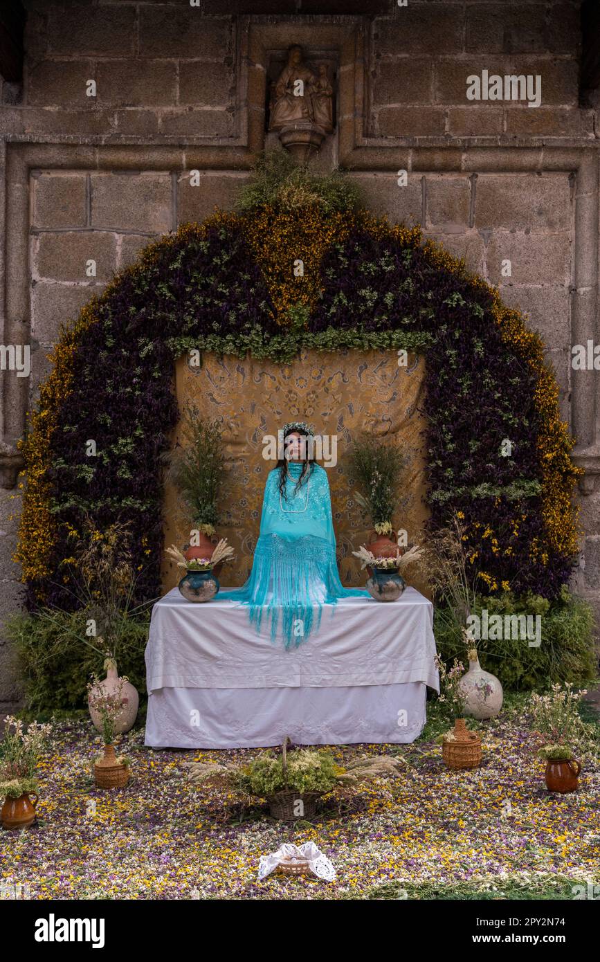 A Maya girl is seen seated at an altar during the traditional ...