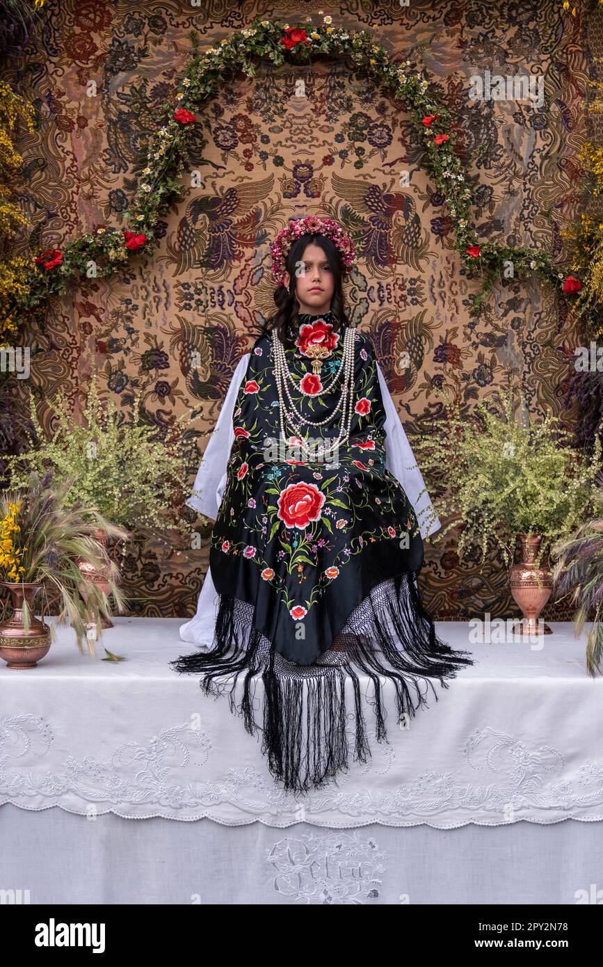 A Maya girl is seen seated at an altar during the traditional ...