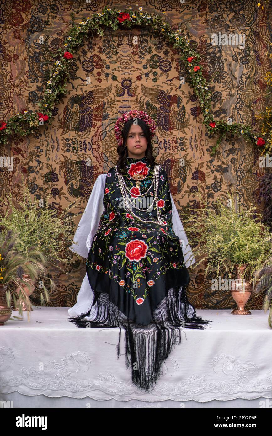 A Maya girl is seen seated at an altar during the traditional ...
