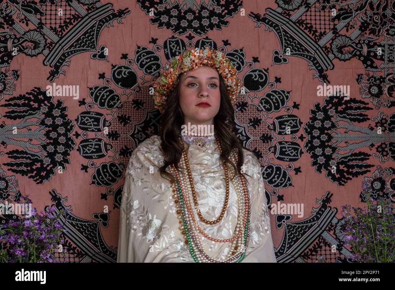 A Maya girl is seen seated at an altar during the traditional ...