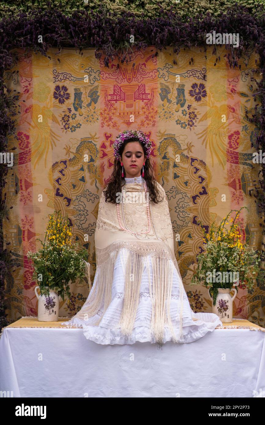 A Maya girl is seen seated at an altar during the traditional ...