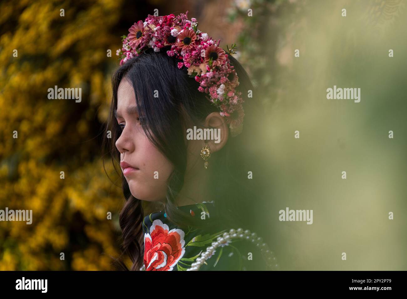 A Maya girl is seen seated at an altar during the traditional ...